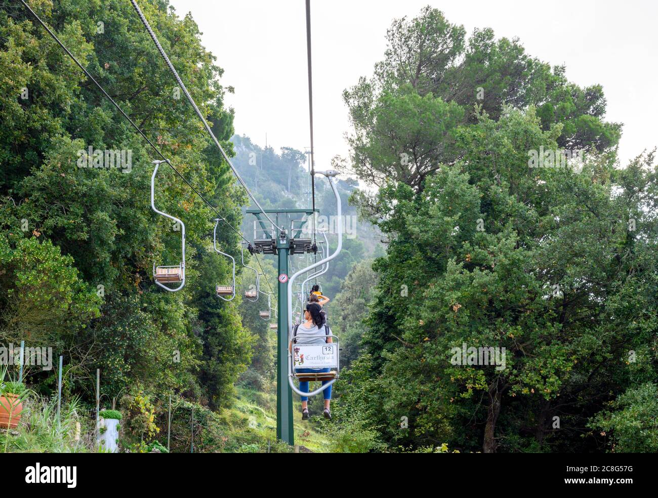 People use chairlifts to get to the summit of Monte Solaro which is the ...