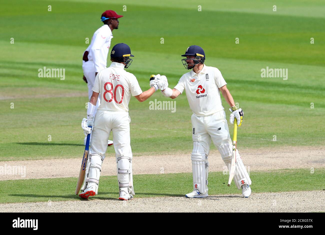 England's Rory Burns (right) is congratulated by Ollie Pope after ...