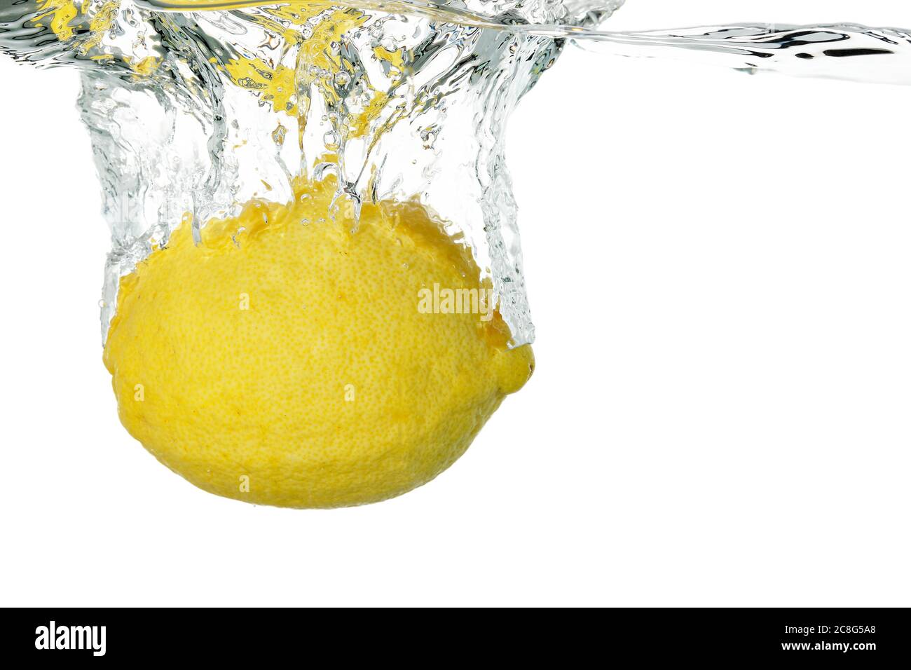 lemon sinking into water on white Stock Photo - Alamy