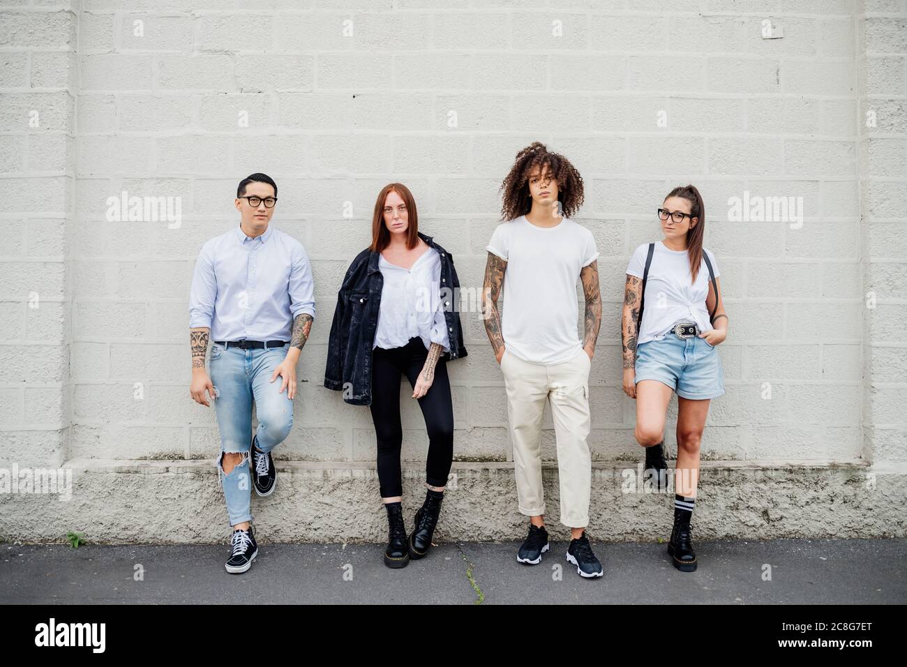 Mixed race group of friends hanging out together in town Stock Photo ...