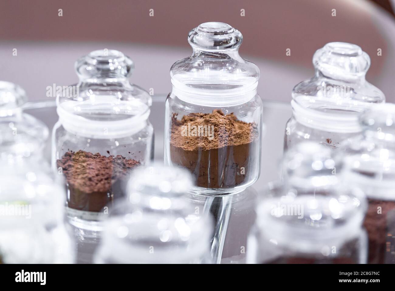 Regular and alkalised cocoa powder on with dar chocolate, in glass jars ...