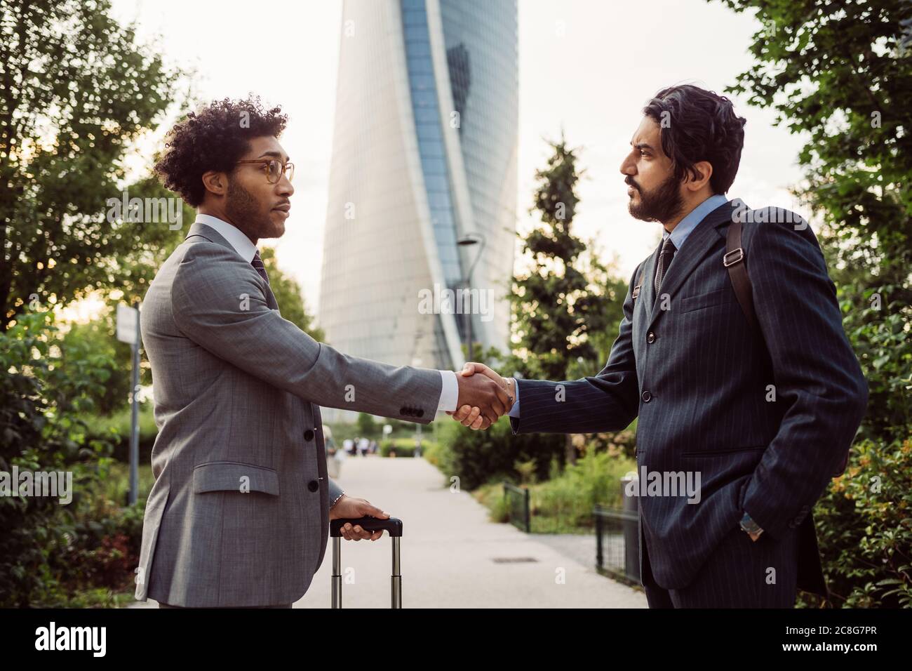 Shaking hands suits hi-res stock photography and images - Alamy