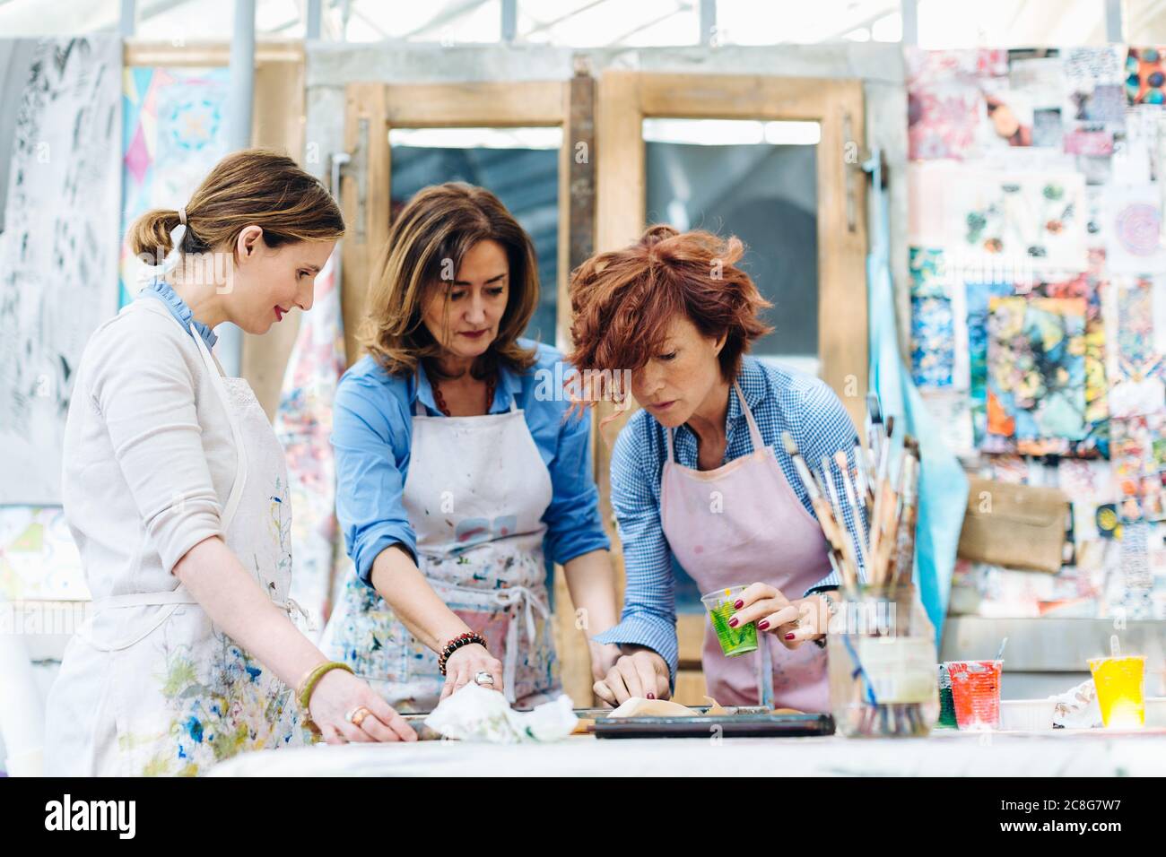 Three women working in creative studio Stock Photo - Alamy