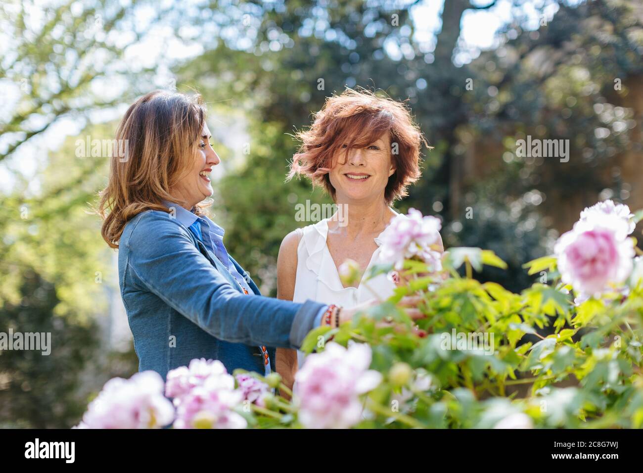 Two women, in rural setting, laughing Stock Photo - Alamy