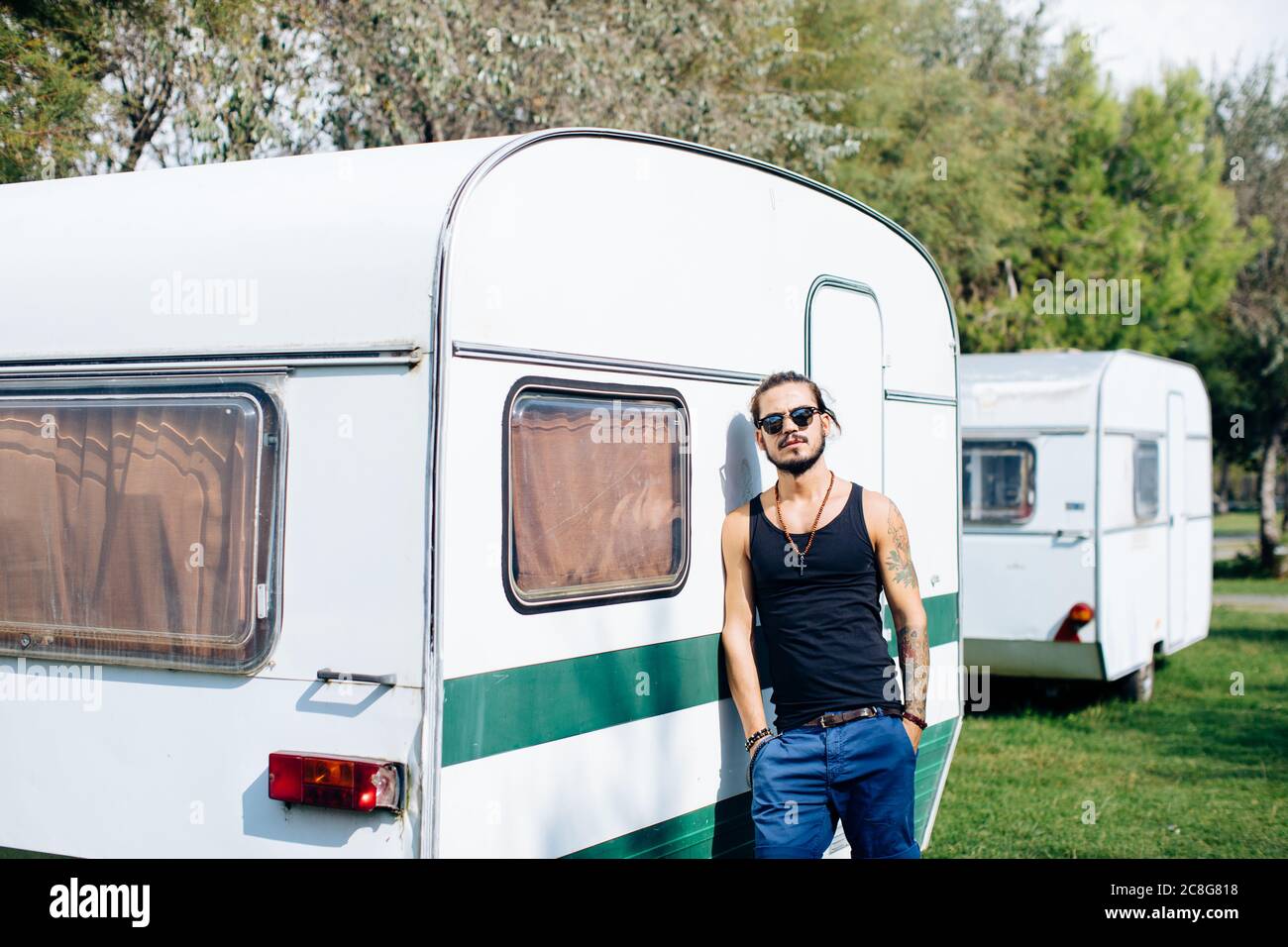 Man leaning against caravan Stock Photo - Alamy