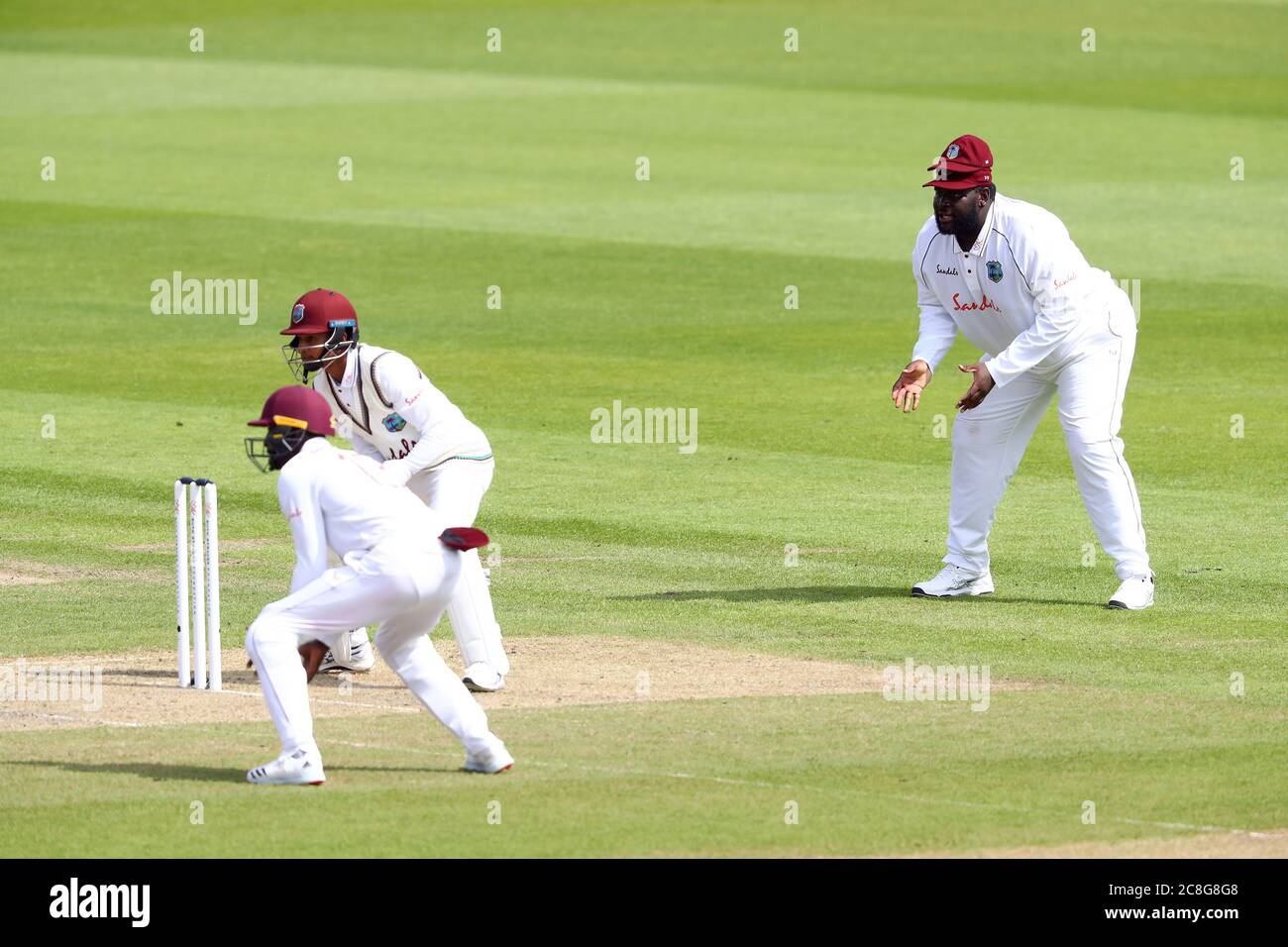 West Indies' Rahkeem Cornwall (right) fields in the slips wearing two ...