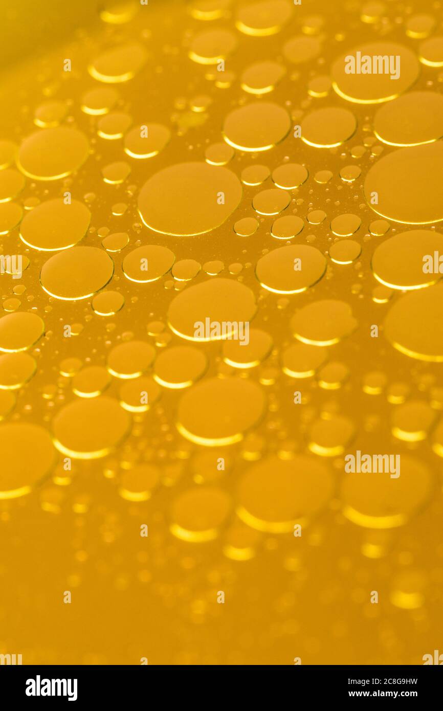 Oil bubbles on the surface of an yellow broth Stock Photo - Alamy