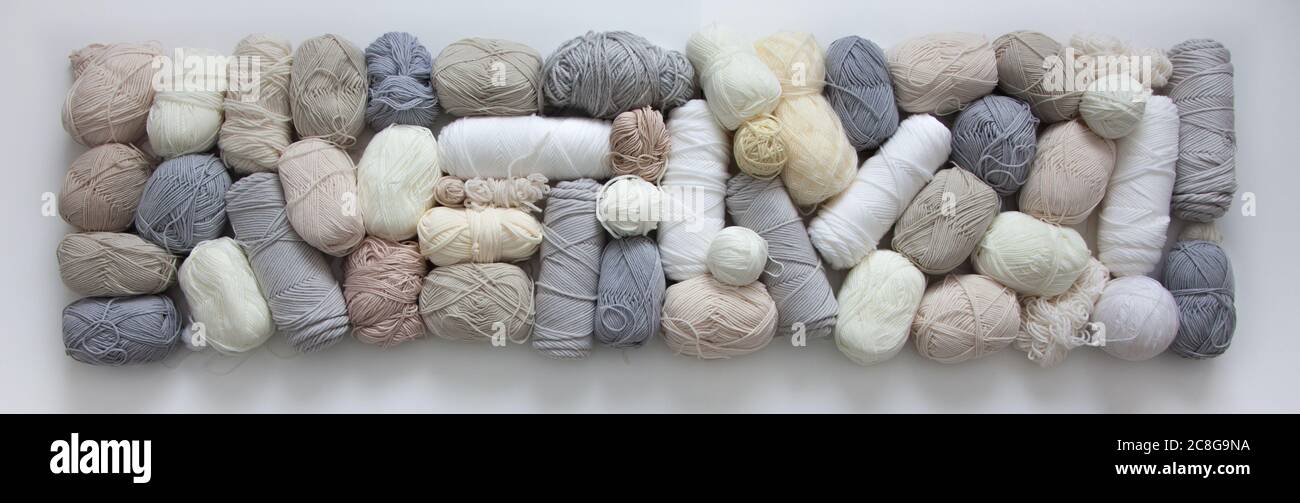 White, light, neutral and grey yarn for knitting. Top view. Long ...