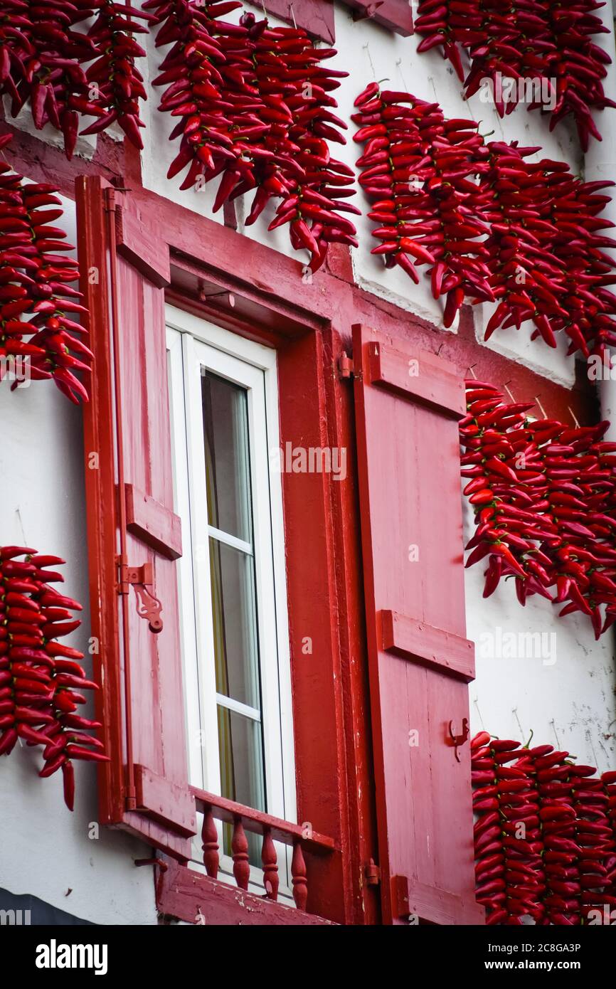 red window with red Espelette peppers Stock Photo - Alamy