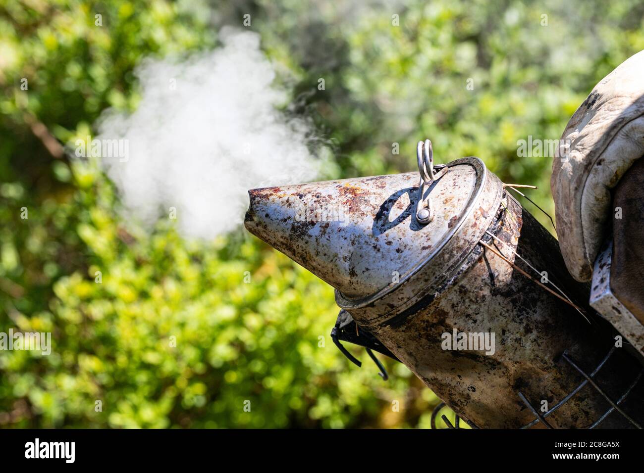 old rust hive smoker smoking Stock Photo - Alamy