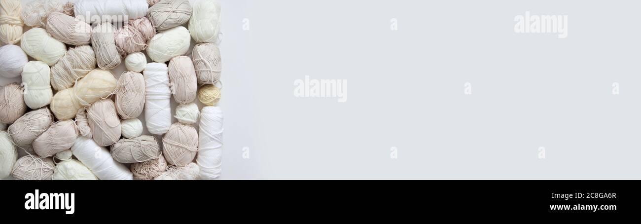 White, light, neutral yarn for knitting. Top view. Long background ...