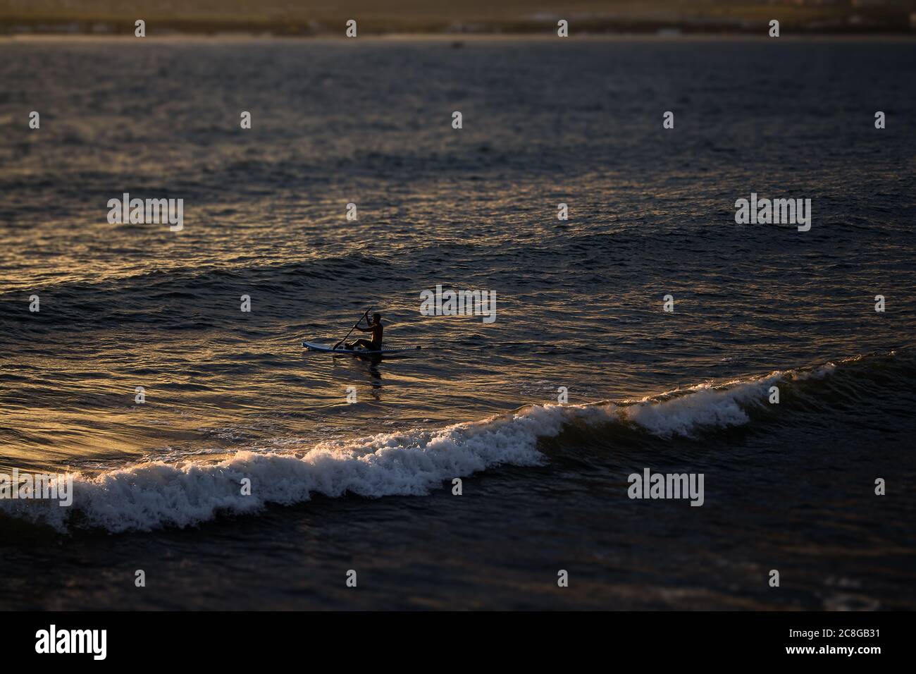 a bright sunset, rays falling on the sea surface, large foam waves ...