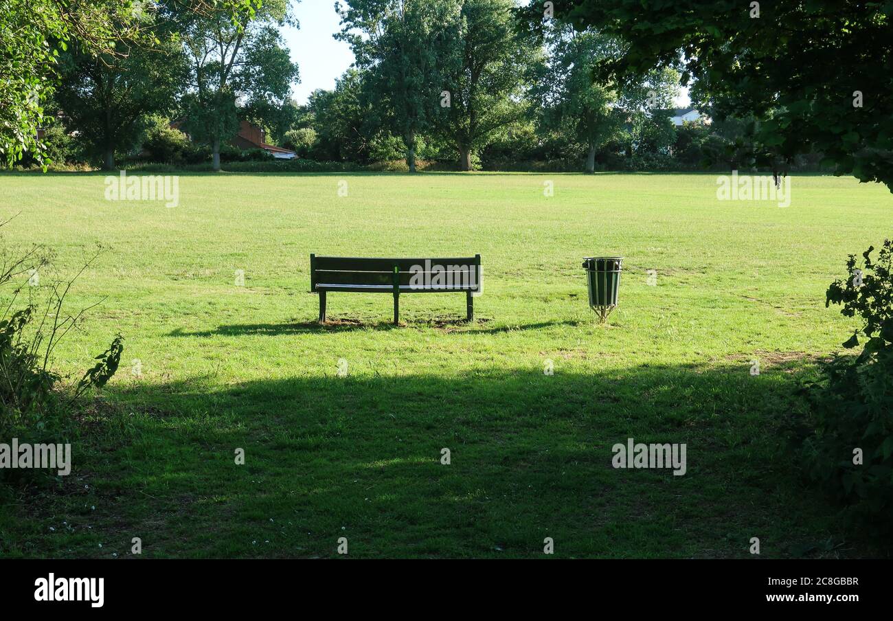 Seat and waste bin on an empty Walsworth Common, Hitchin, Hertfordshire ...