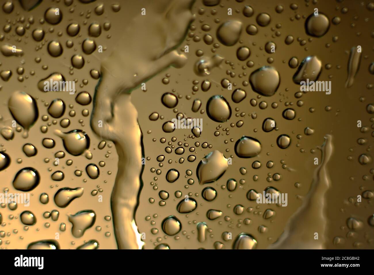 Water droplets on a golden background Stock Photo - Alamy