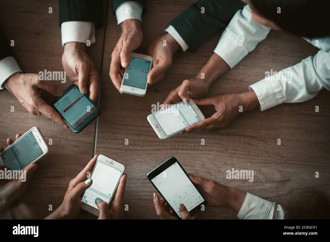 Team of businesspeople chatting on mobile phones. Office workers using ...