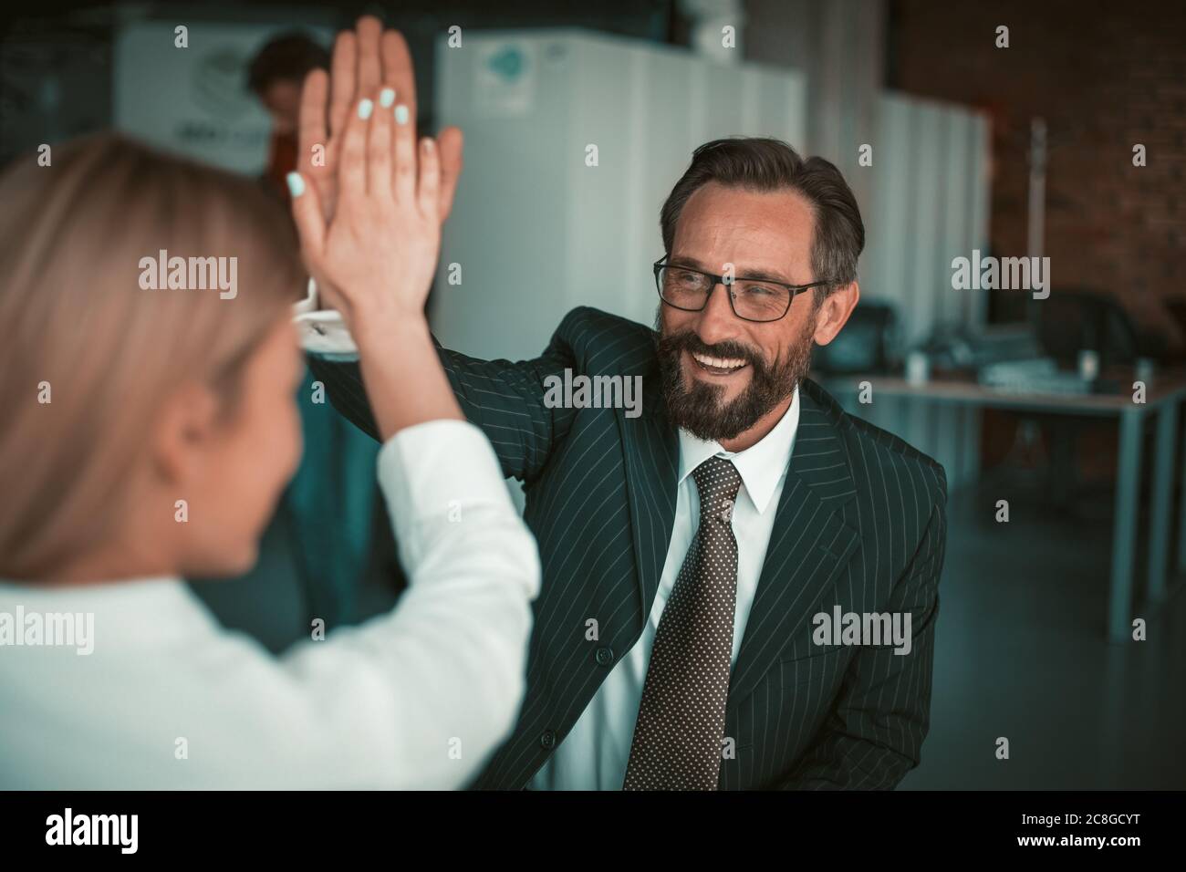 High five gesture from businesspeople in office. Happy caucasian man ...