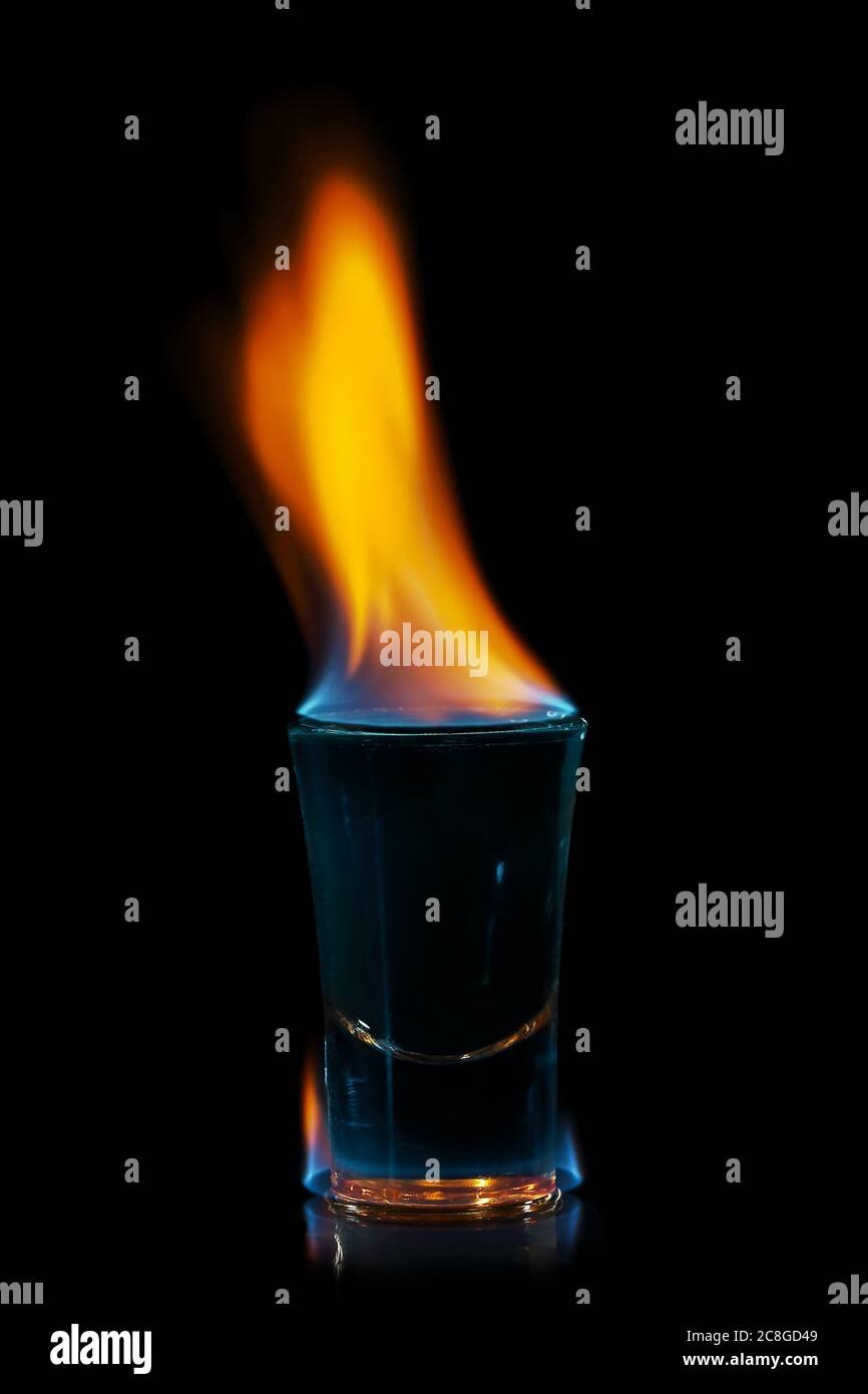 shot glass on fire against black background Stock Photo - Alamy