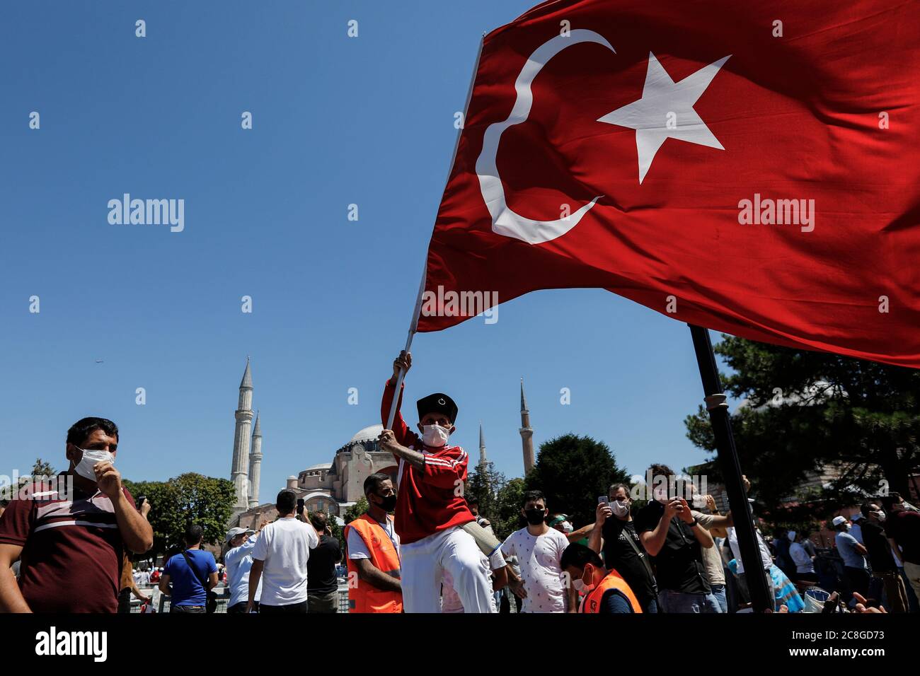 Istanbul, Turkey. 24th July, 2020. A man holds Turkish flag while ...