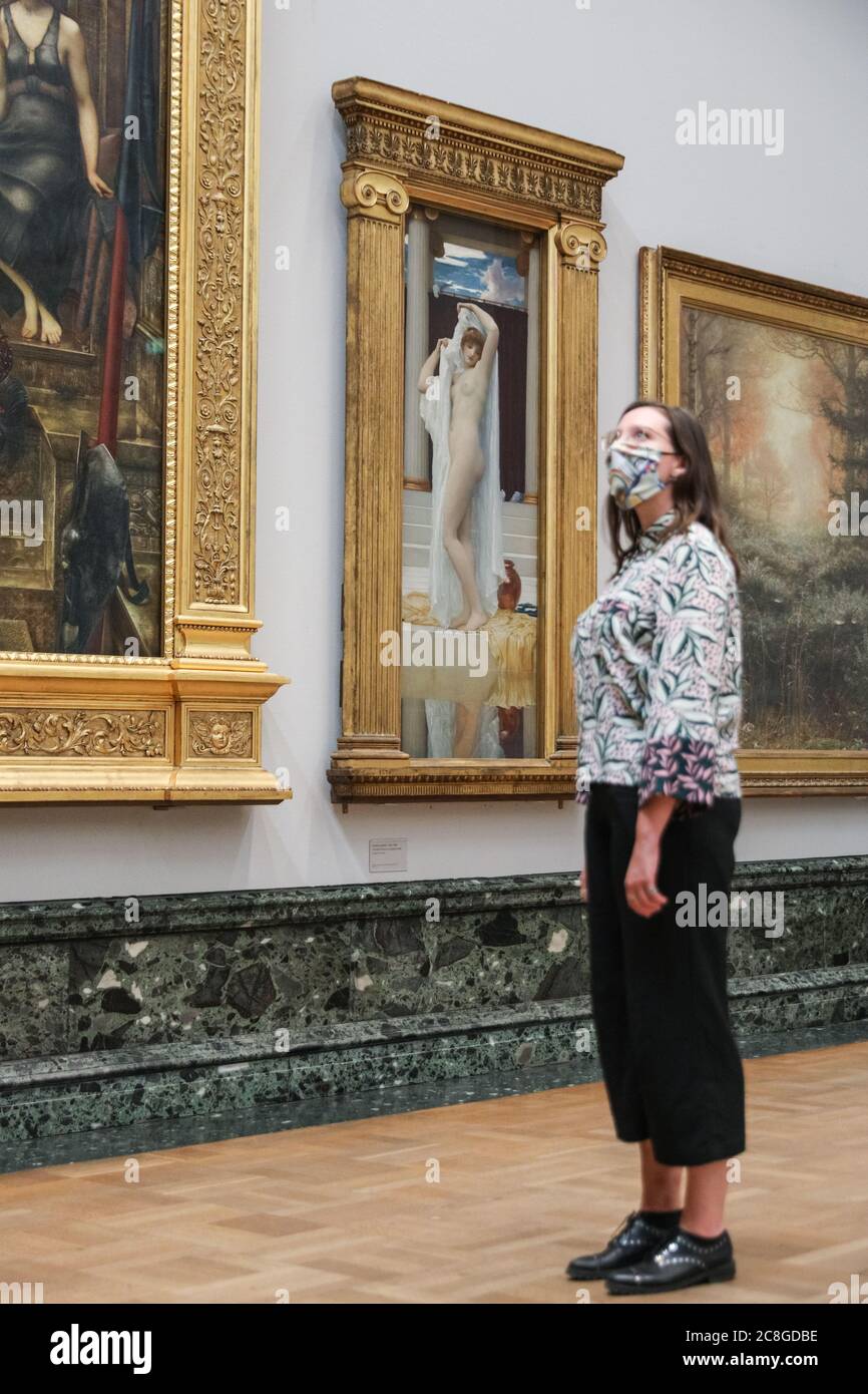 London, UK. 24th July, 2020. An assistant looks at various works in the ...