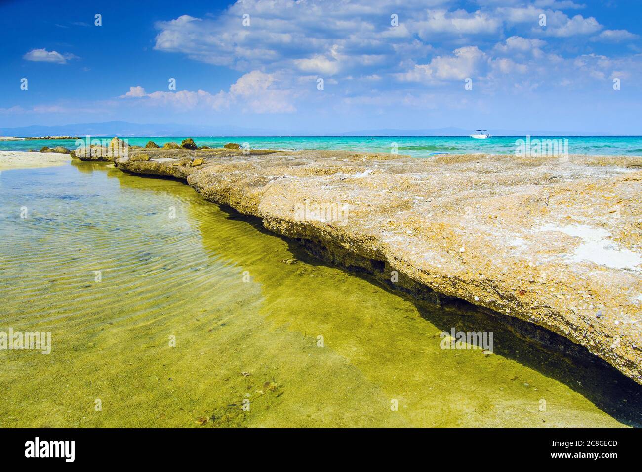 Colorful tropical beach with huge rock Stock Photo - Alamy
