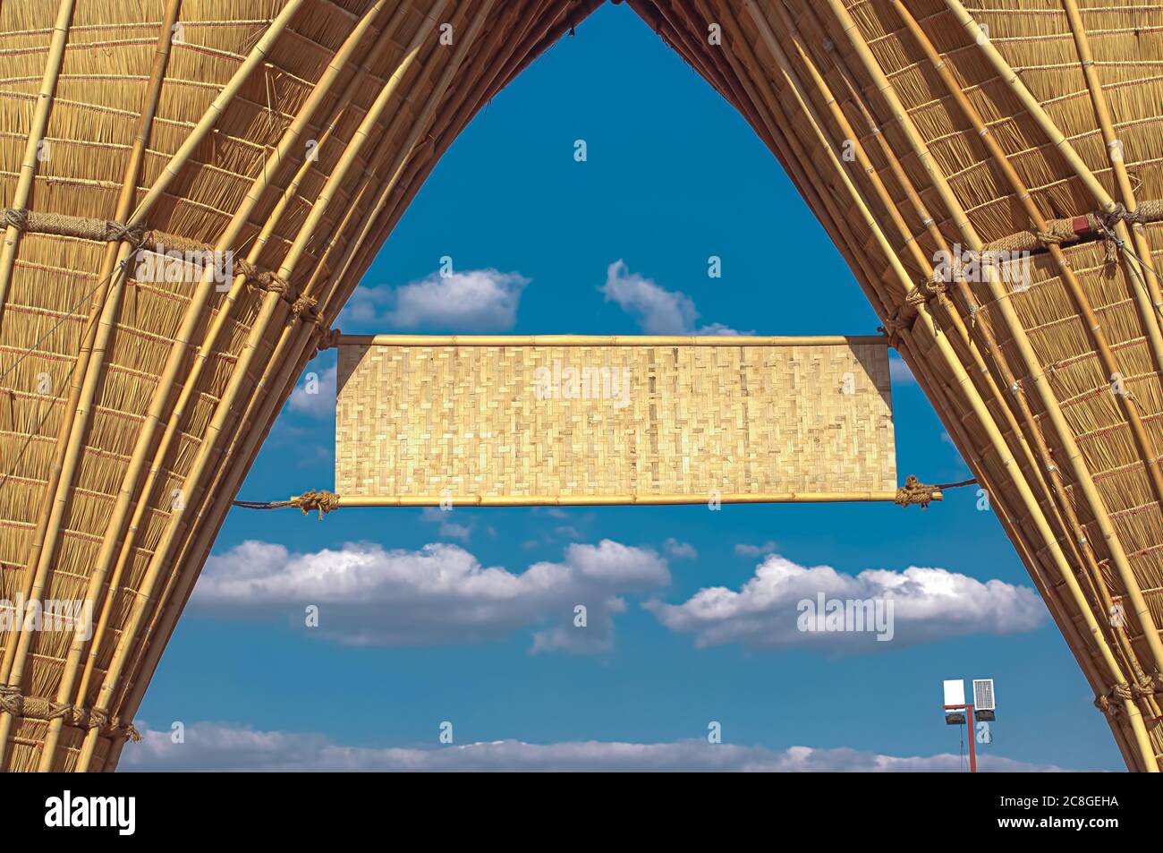 Large blank bamboo signs hanging on a large bamboo arch against the ...