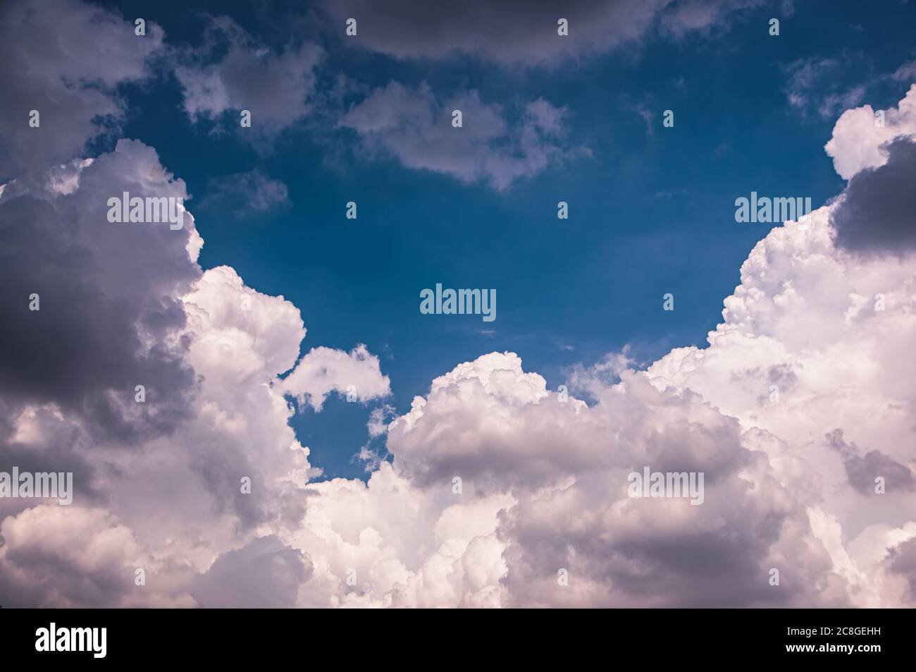 Massive rain clouds, Cumulonimbus fluffy cloud forming in the blue sky ...