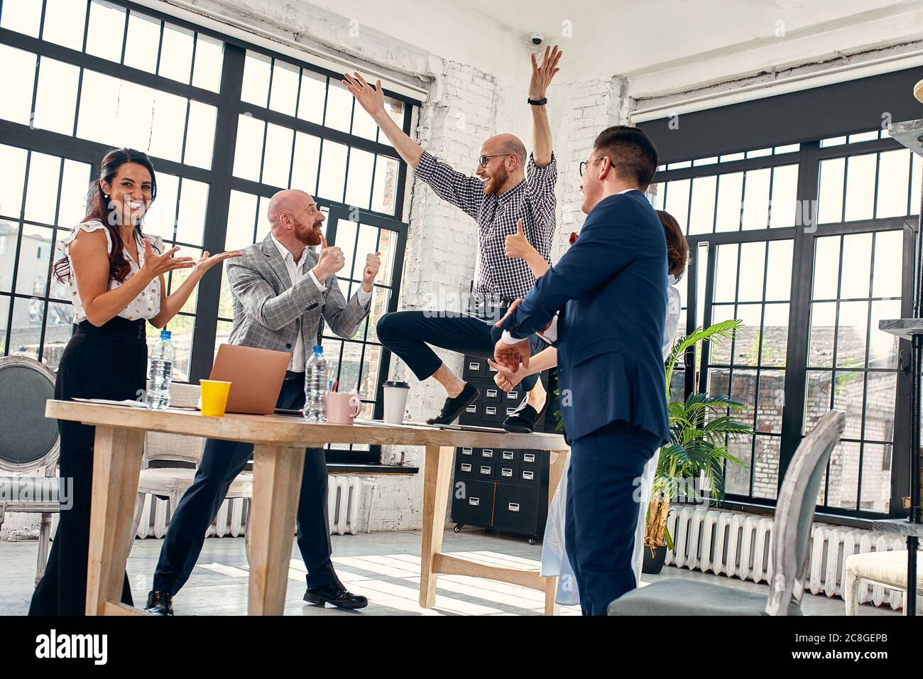 Excited diverse business team employees screaming celebrating good news ...