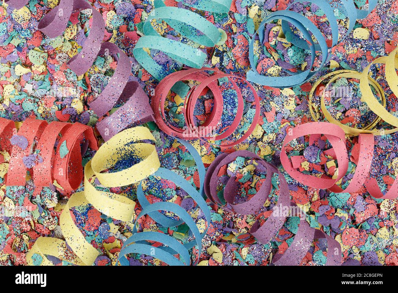 colorful party streamers on confetti Stock Photo - Alamy