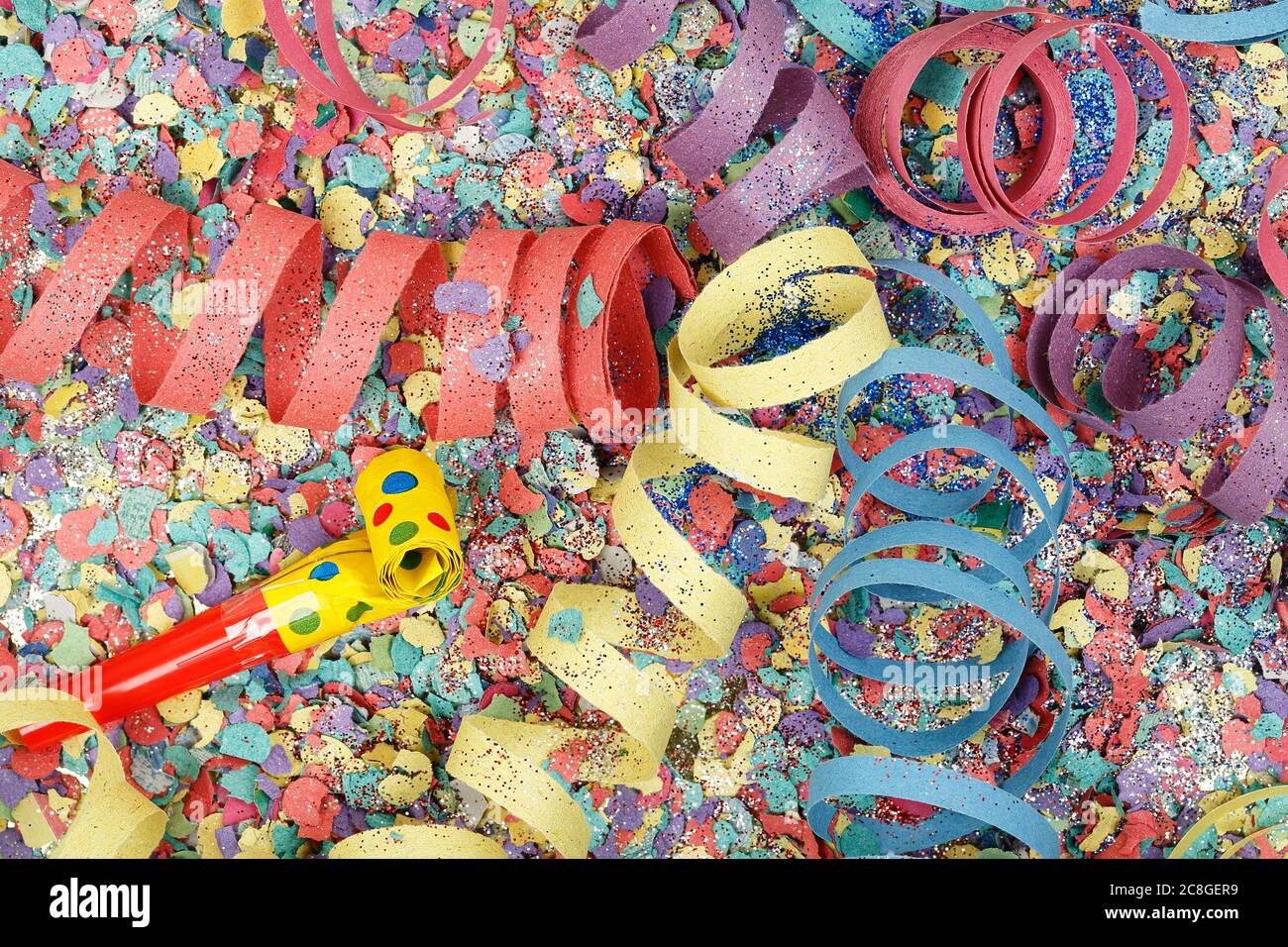 colorful party streamers on confetti Stock Photo - Alamy