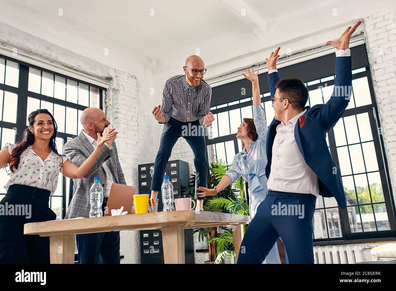 Excited diverse business team employees screaming celebrating good news business win corporate ...