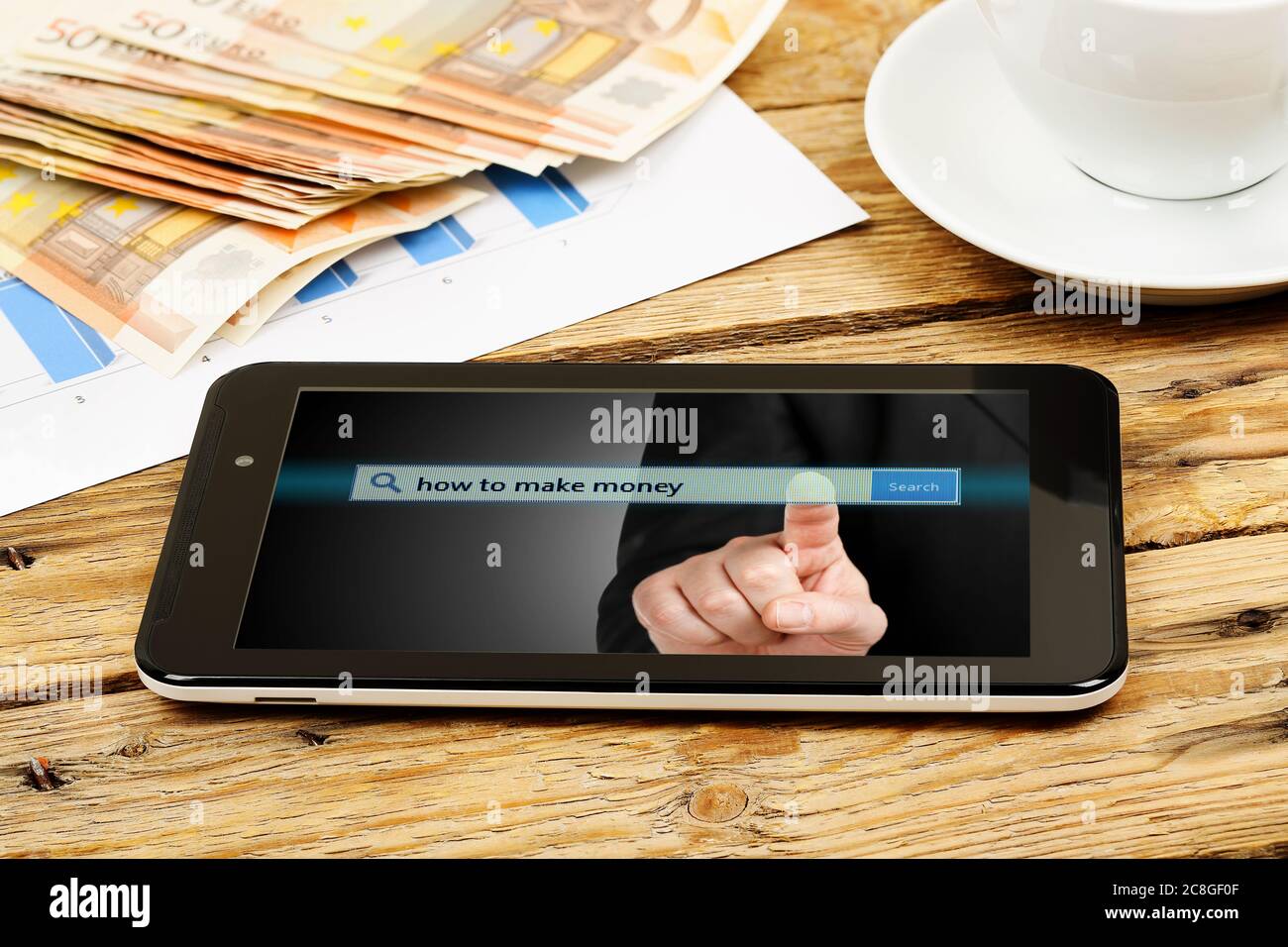 tablet computer with cash and graph on desk, making money concept Stock ...