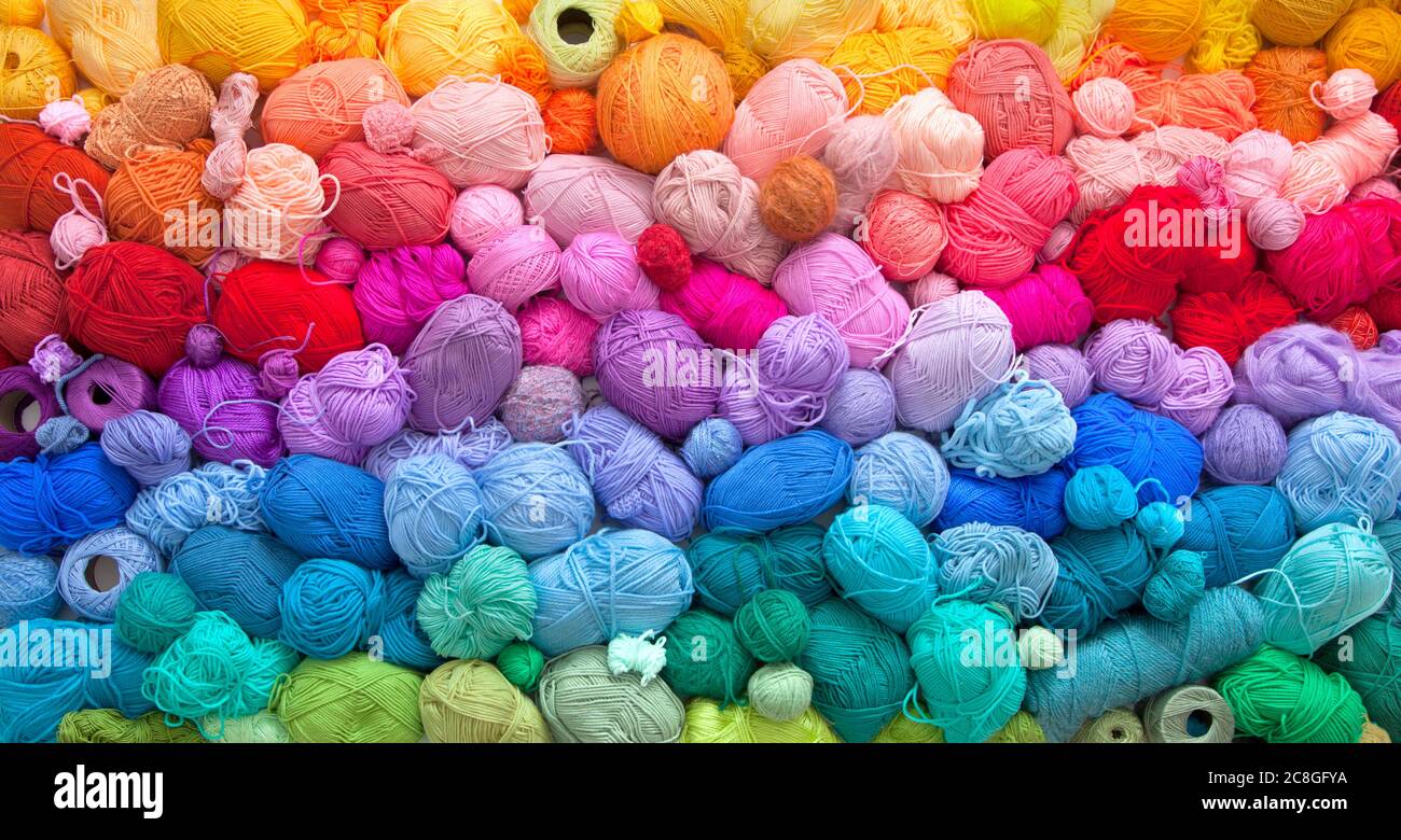 Colored balls and skiens of yarn for knitting. Top view. Rainbow colors ...