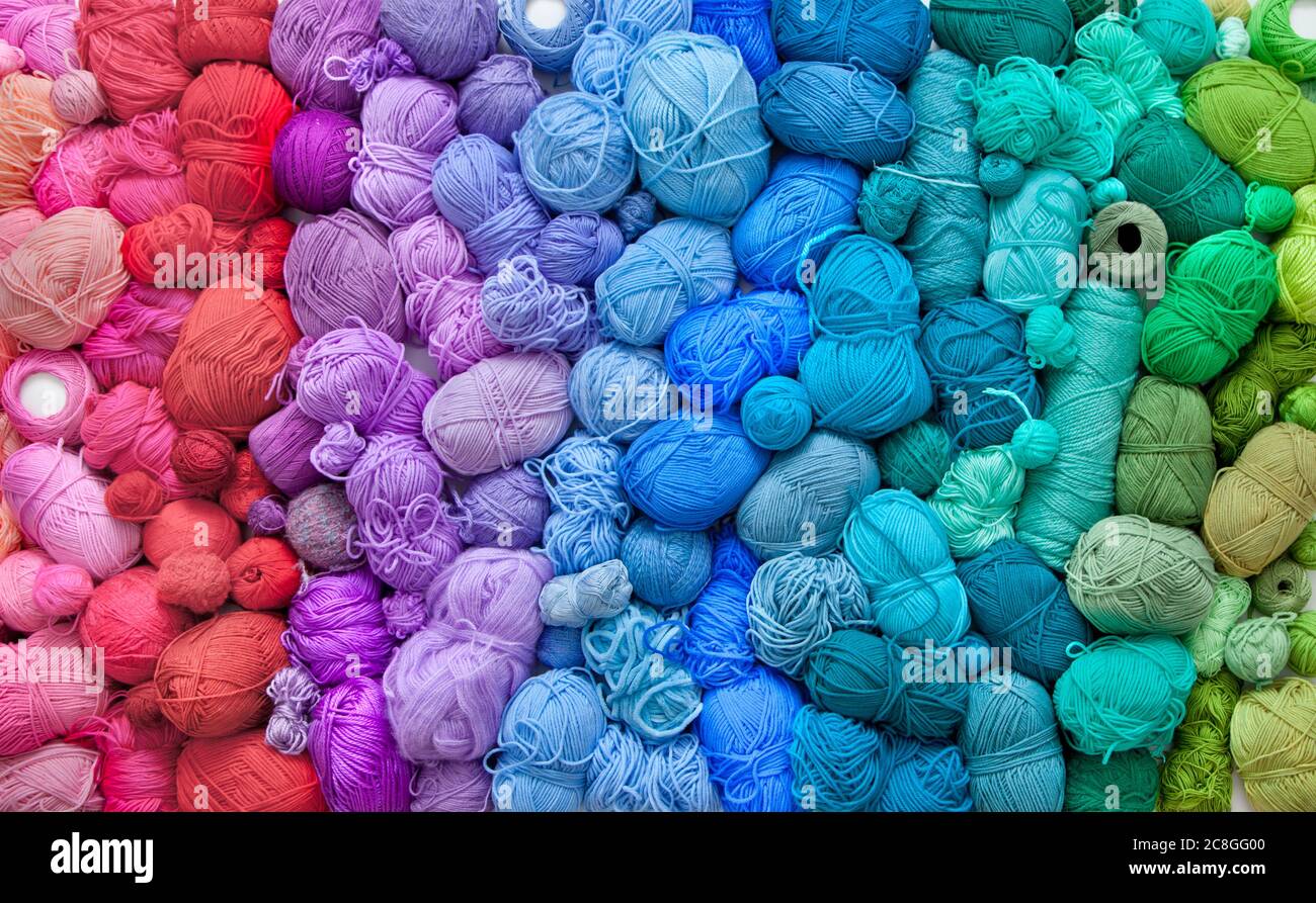 Colored balls and skiens of yarn for knitting. Top view. Rainbow colors ...