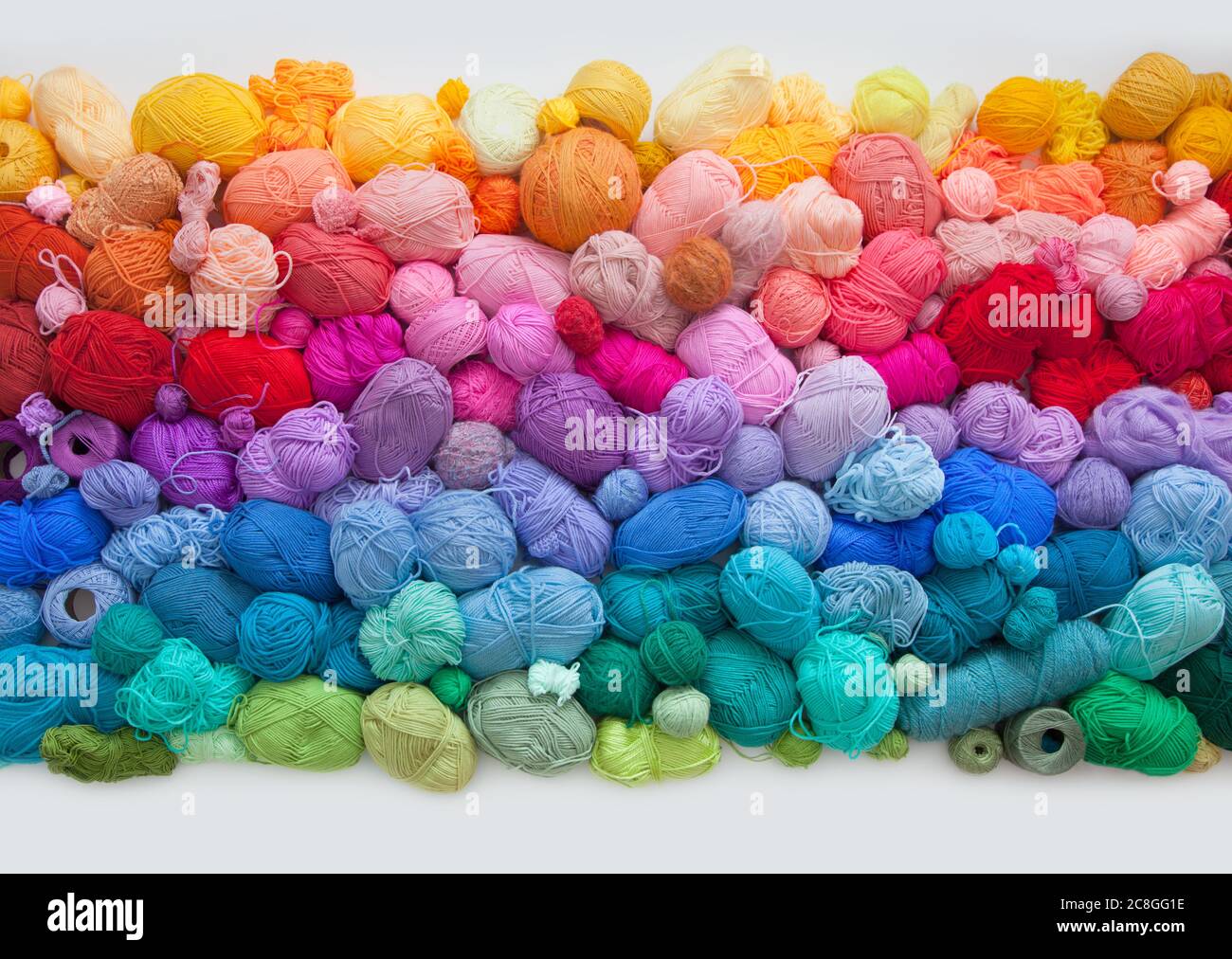 Colored balls and skiens of yarn for knitting. Top view. Rainbow colors ...