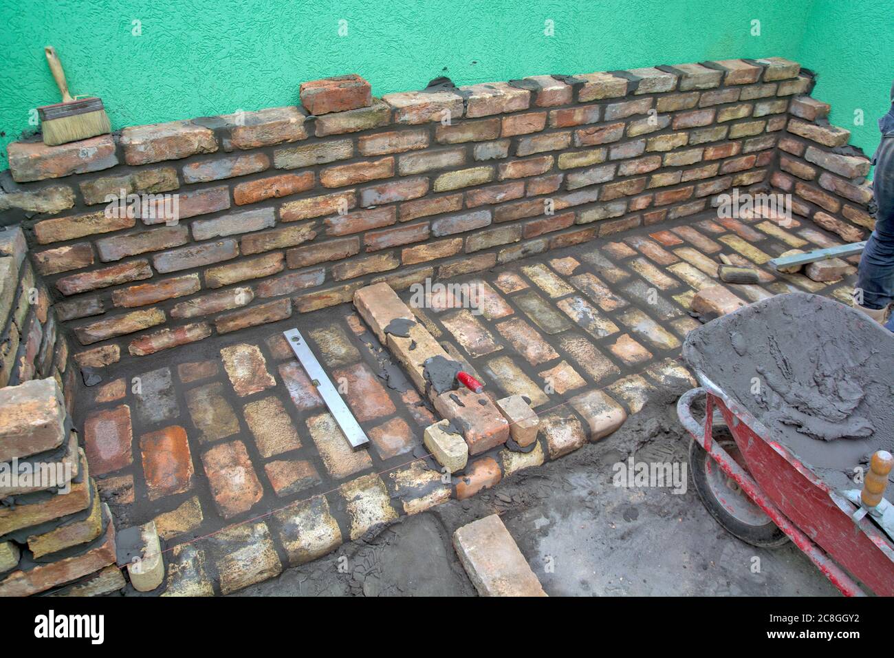 Parked trolley, mortar and tools to help build the building. Several of ...
