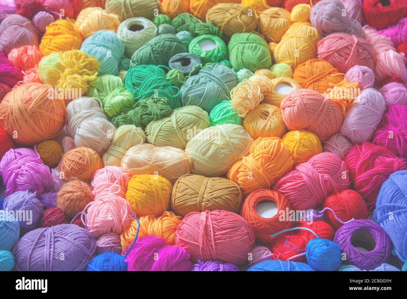 Colored balls and skiens of yarn for knitting. Top view. Rainbow colors ...