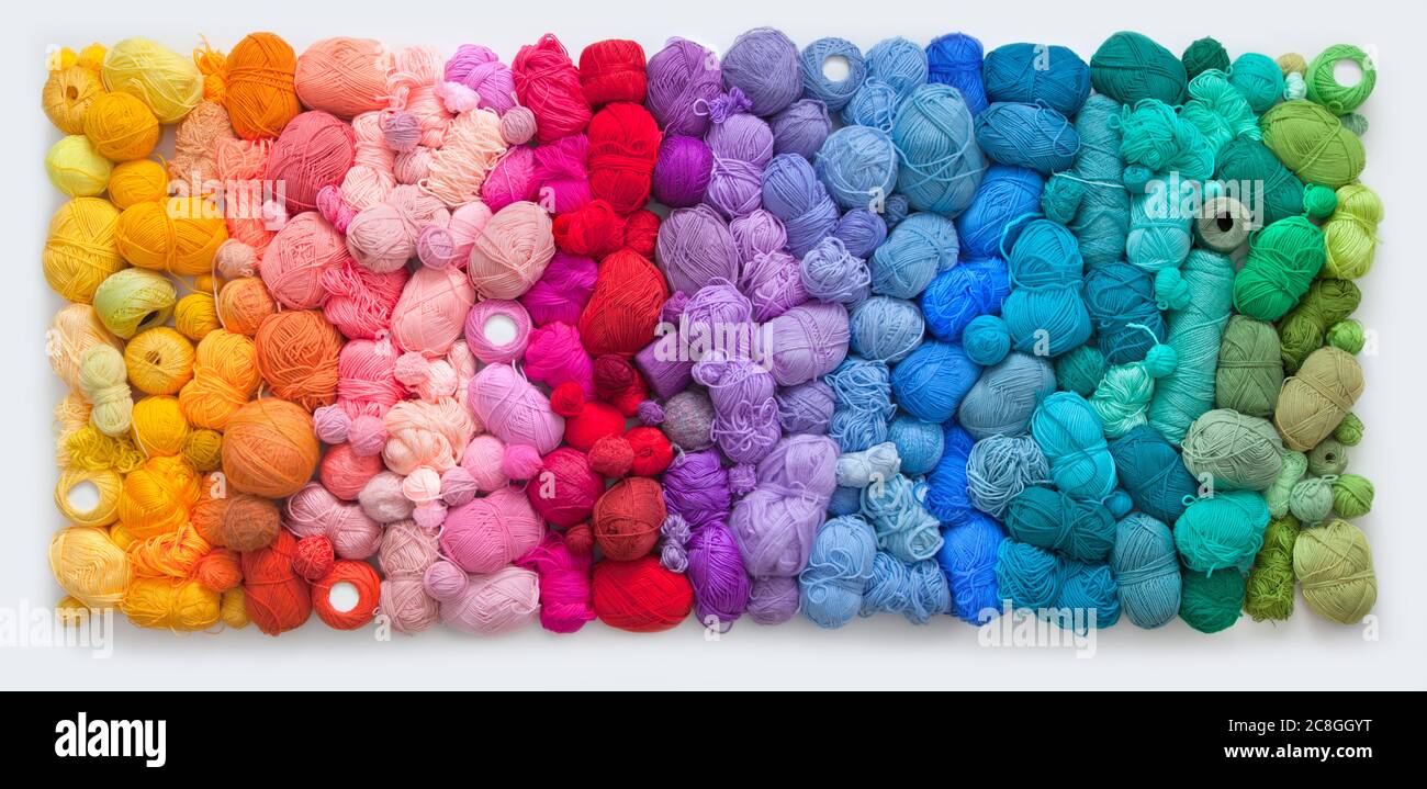 Colored balls and skiens of yarn for knitting. Top view. Rainbow colors ...