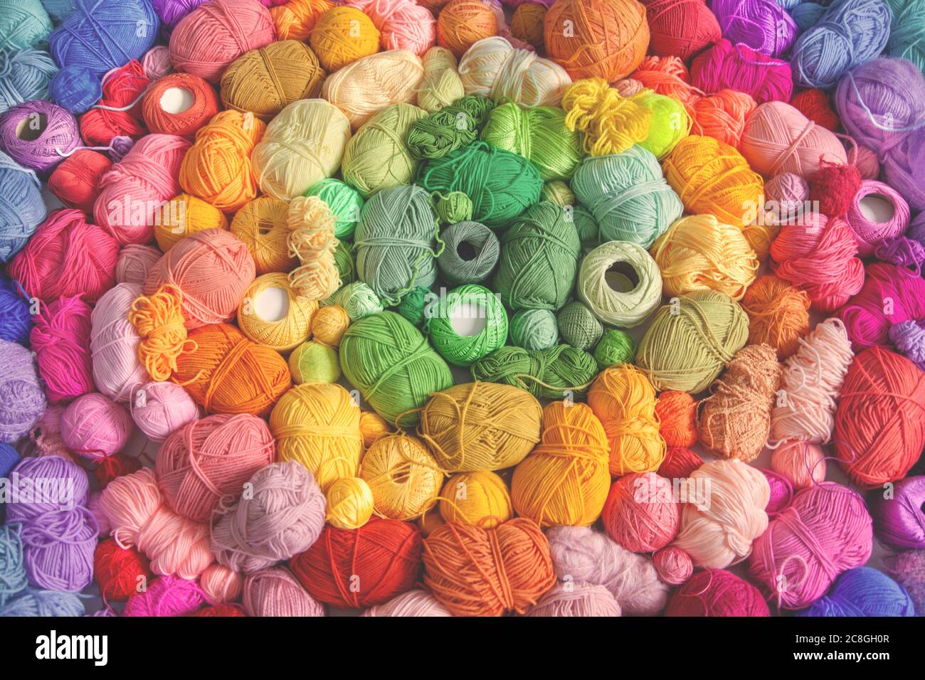 Colored balls and skiens of yarn for knitting. Top view. Rainbow colors ...