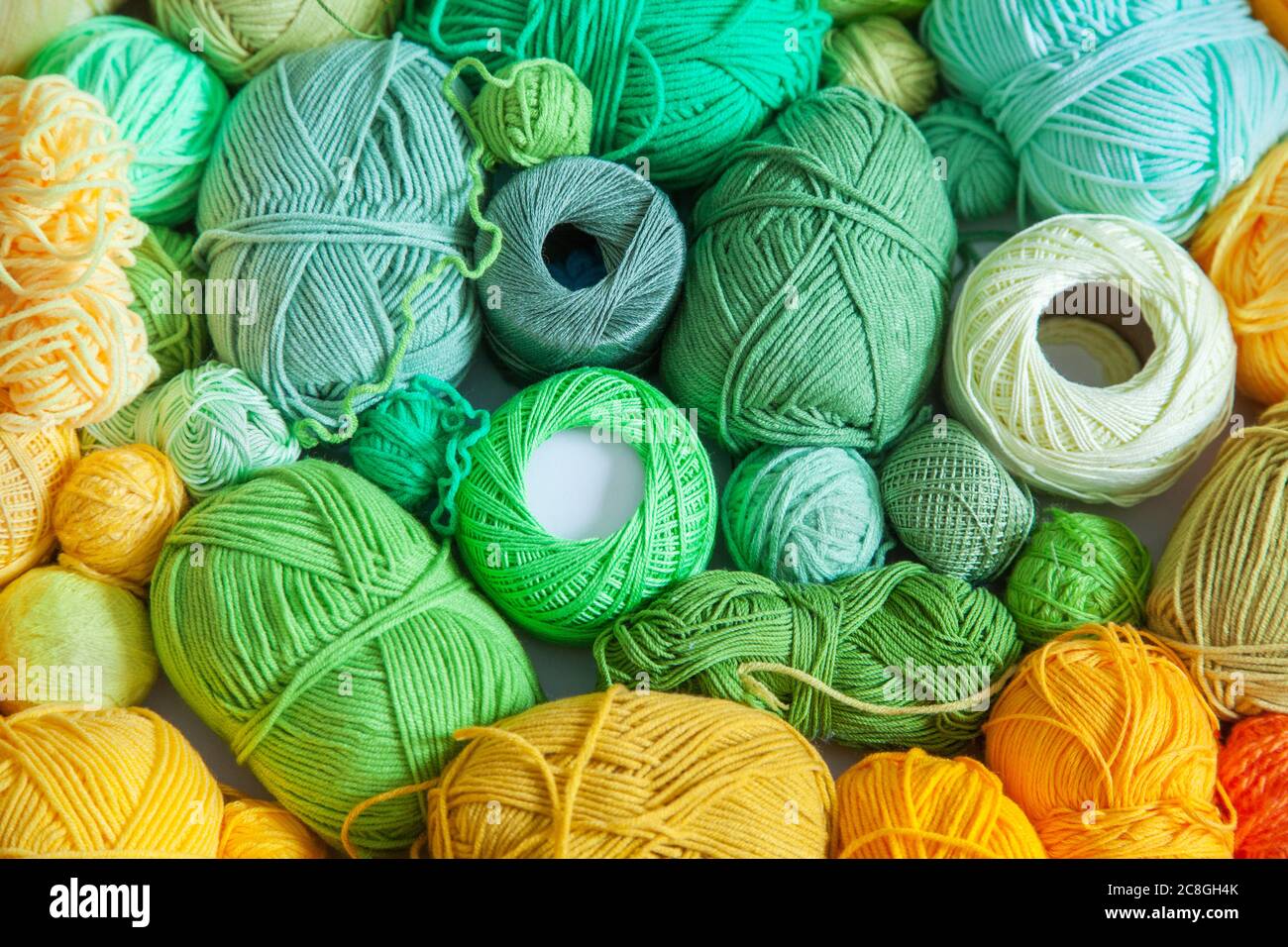 Colored balls and skiens of yarn for knitting. Top view. Rainbow colors ...