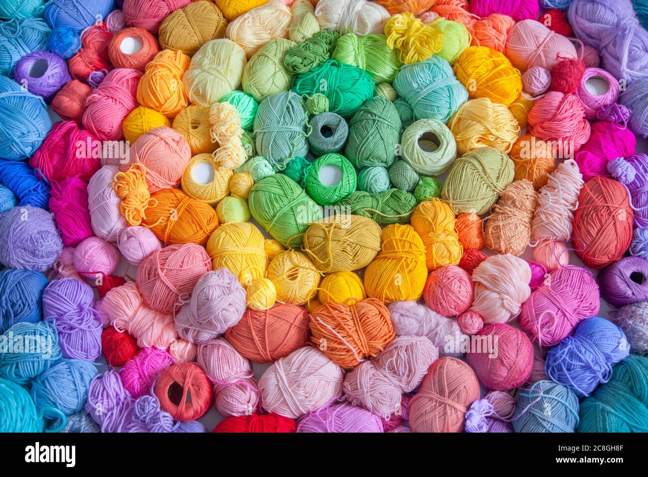 Colored balls and skiens of yarn for knitting. Top view. Rainbow colors ...