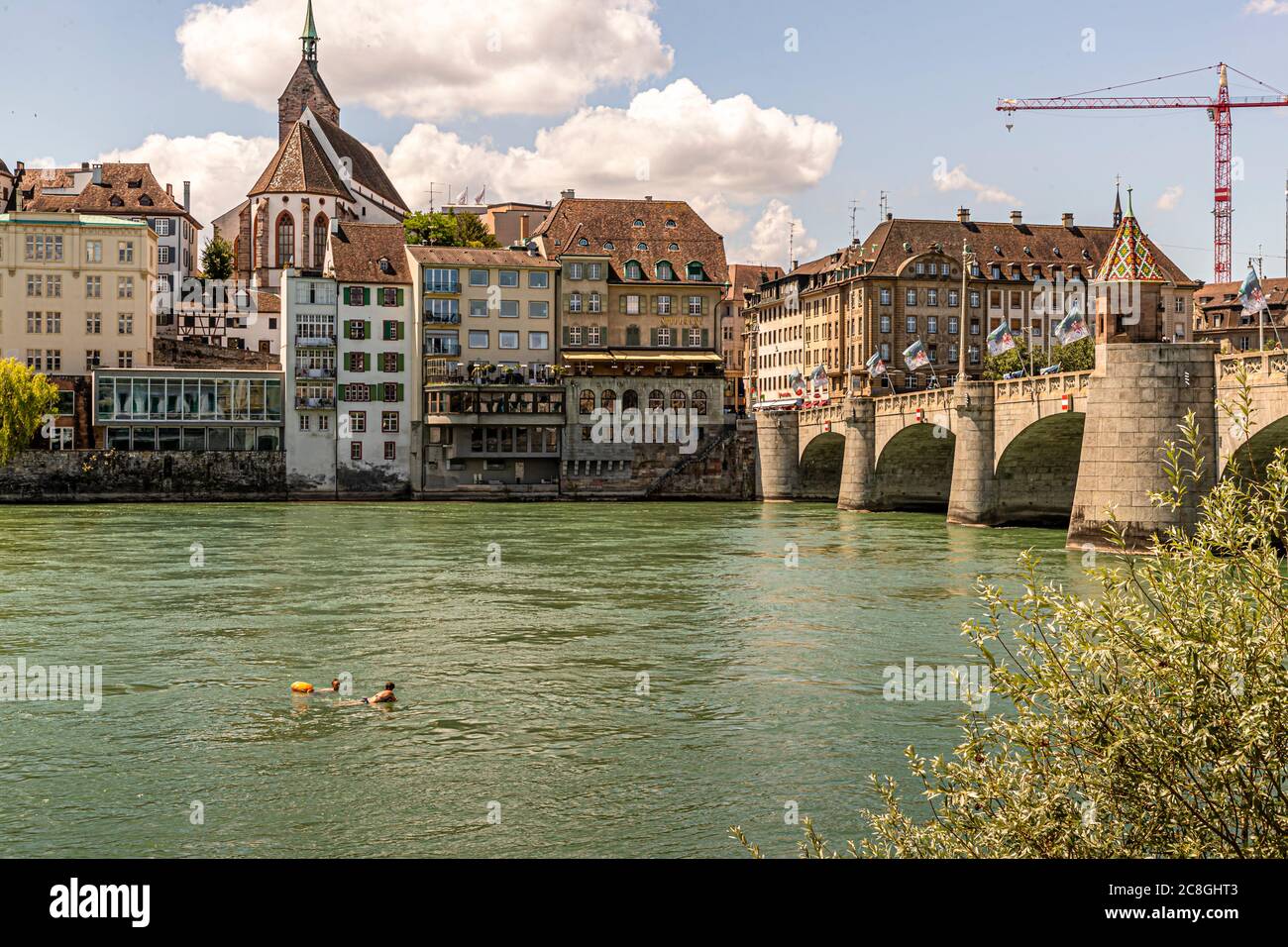 Swimmers in the River Rhine in Basel, Switzerland. On the banks of the ...