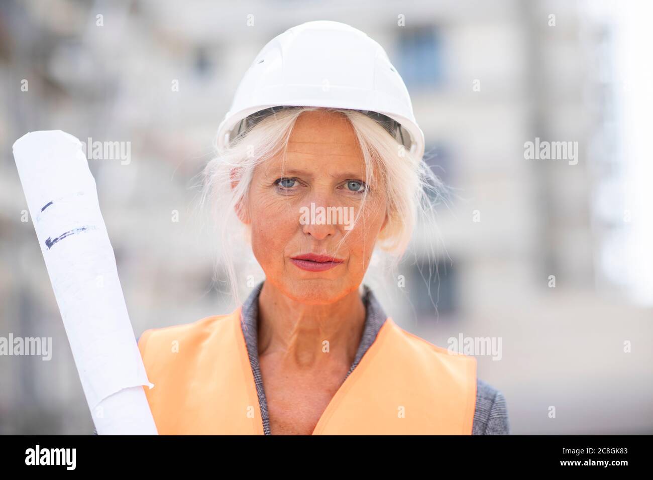 Architect older woman with helmet and plan Stock Photo - Alamy