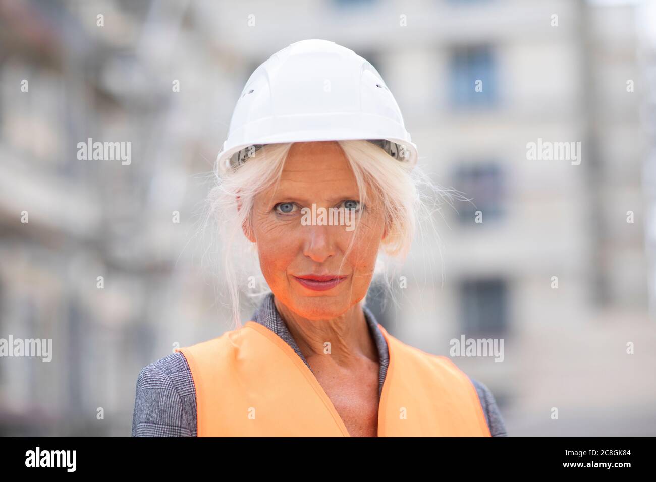 Architect older woman with helmet and plan Stock Photo - Alamy