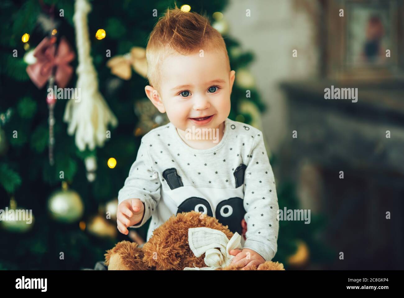 Cute baby sitting christmas tree hi-res stock photography and images ...
