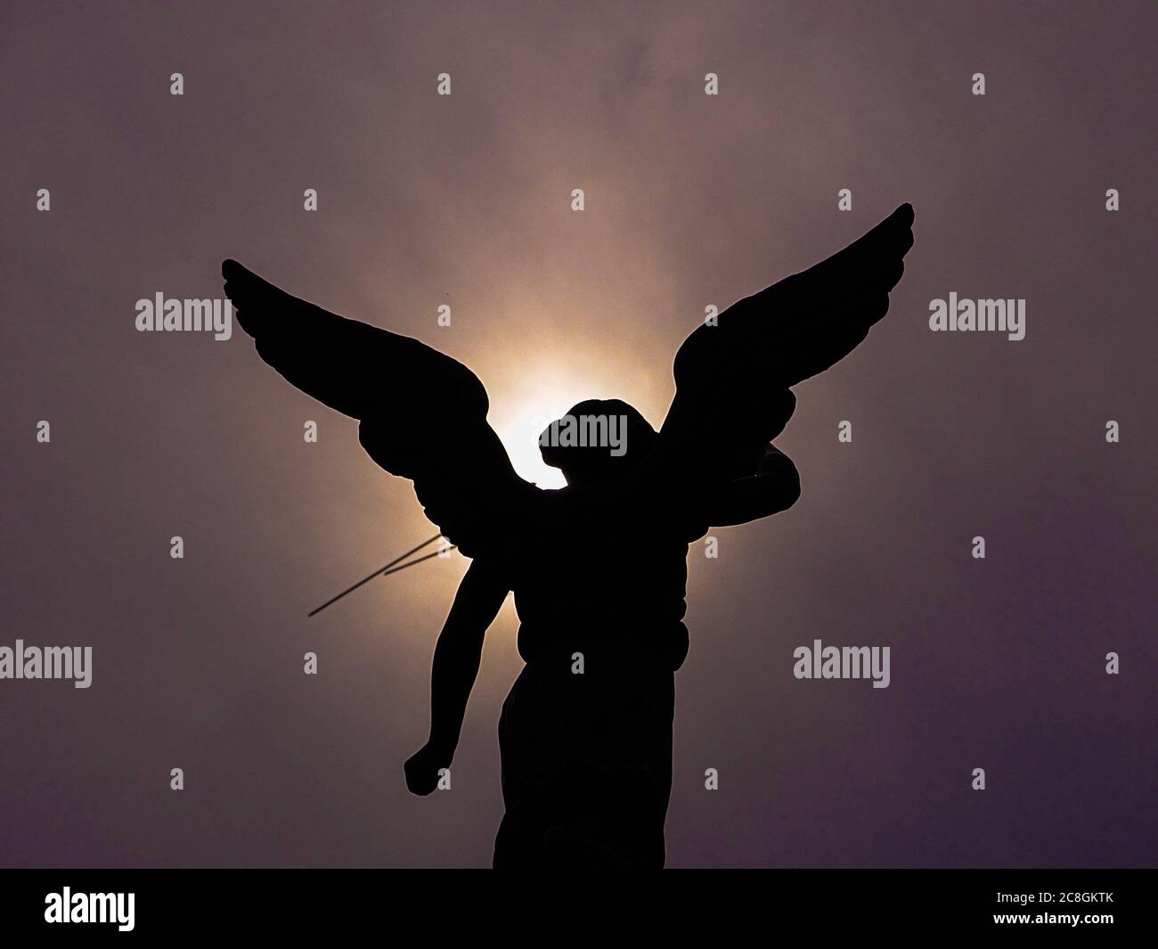 Angel statue facing the sun Stock Photo - Alamy