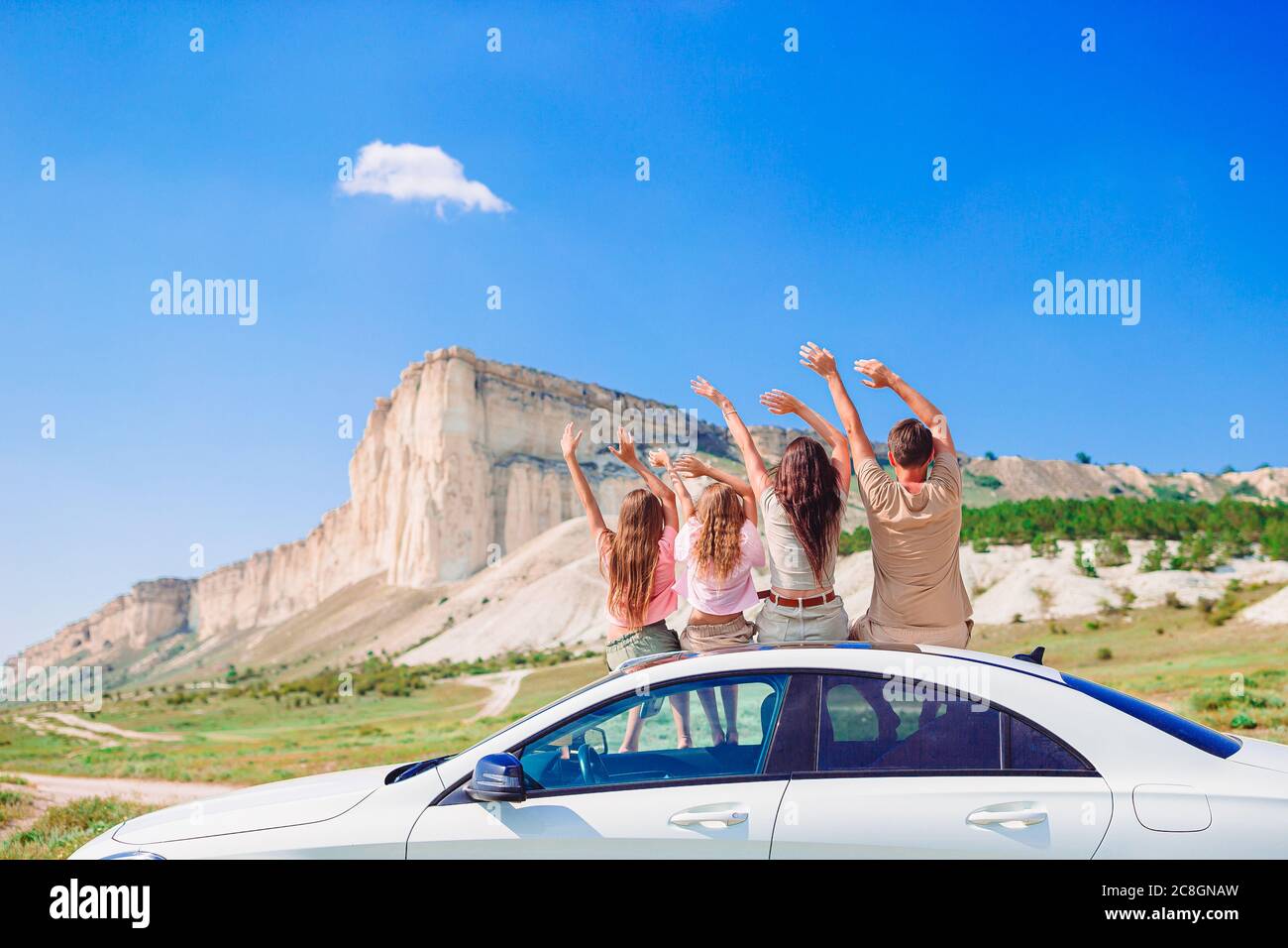 Parents and two little kids on summer car vacation Stock Photo - Alamy