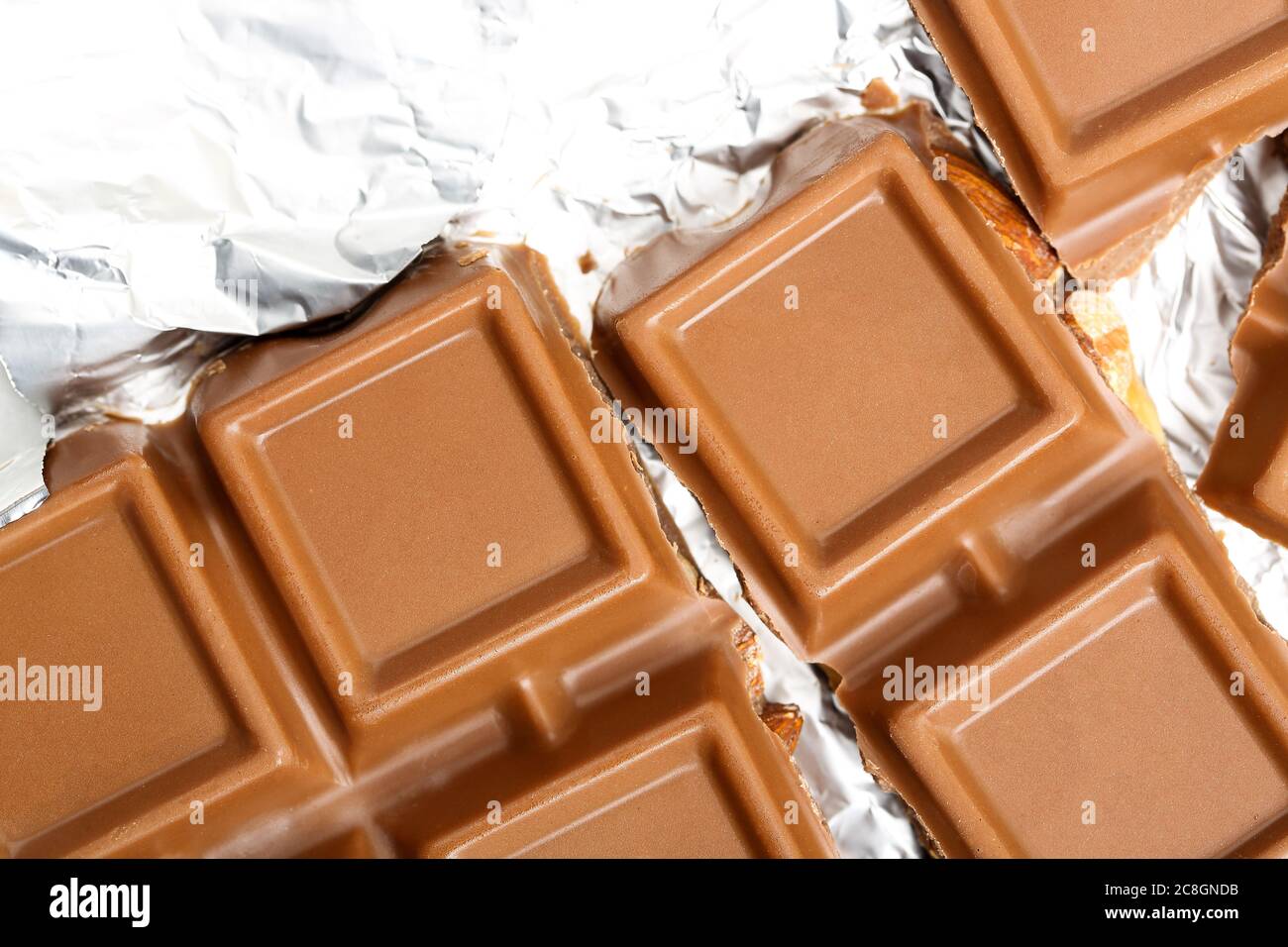 broken bar of chocolate closeup on foil Stock Photo - Alamy
