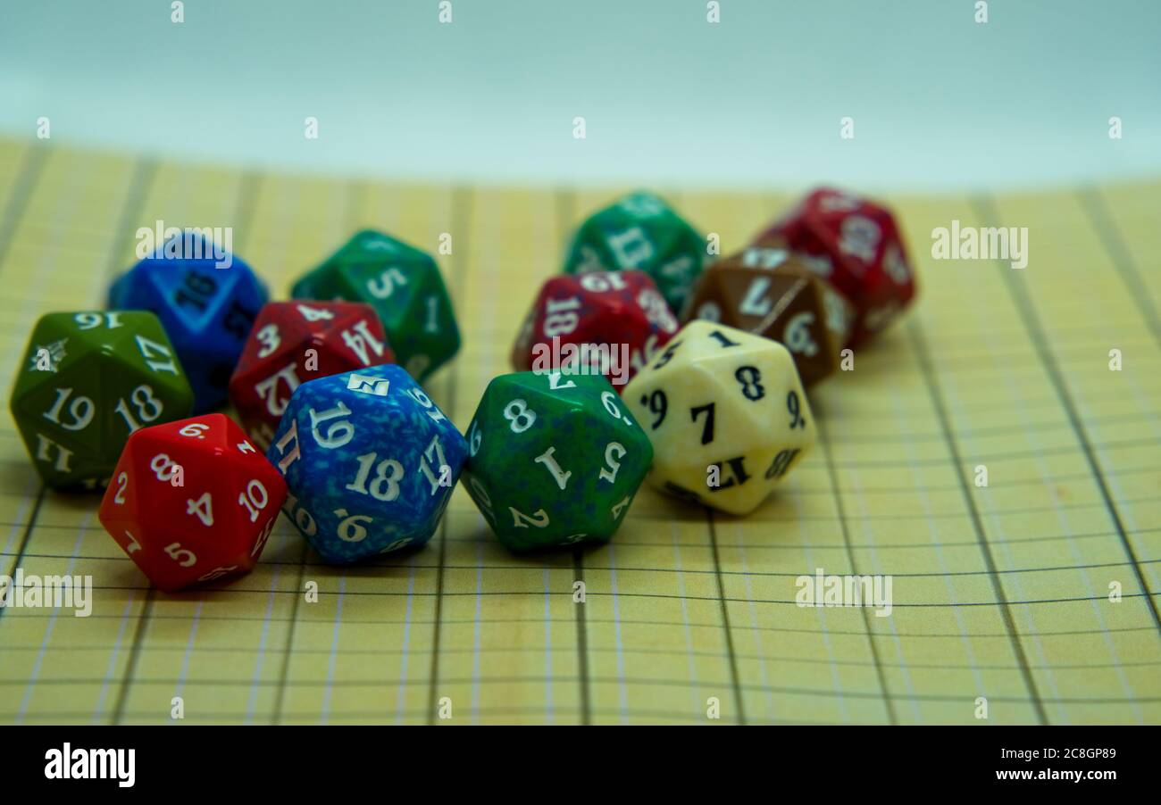 Yellow role-playing board with several colored dice on top in a ...