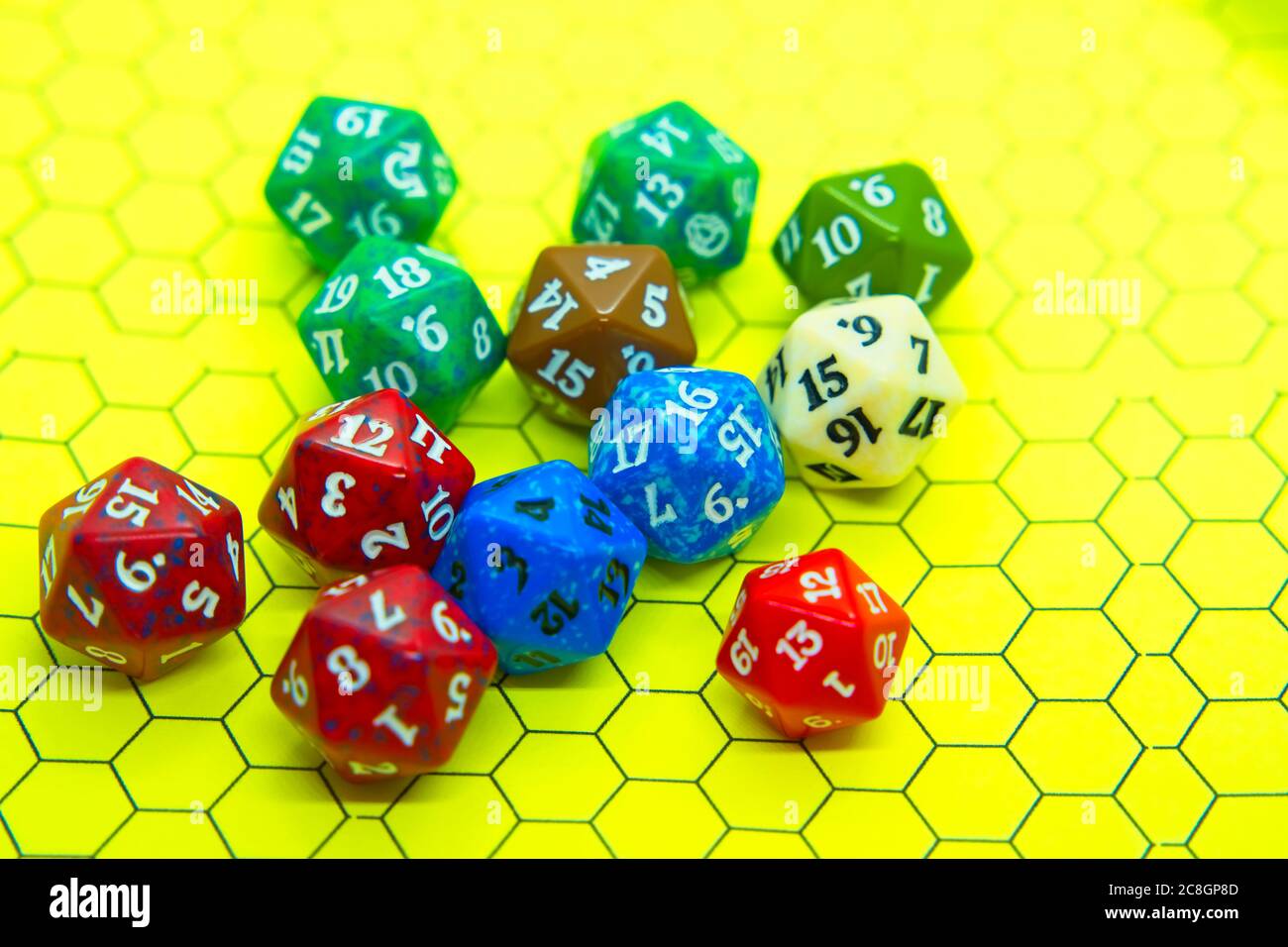 Yellow role-playing board with several colored dice on top in a ...