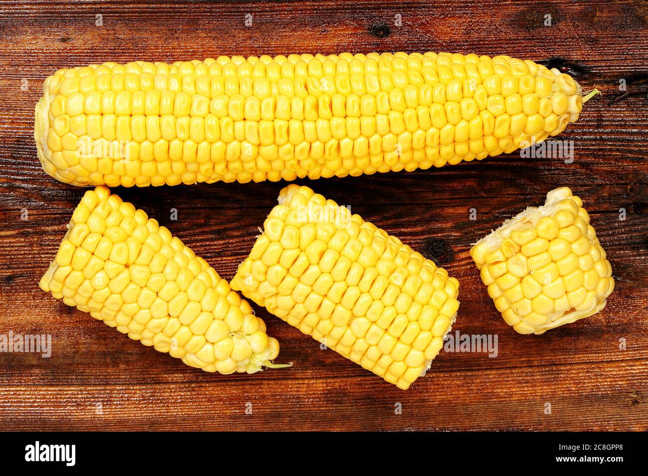 whole and cut ear of corn on wood Stock Photo - Alamy